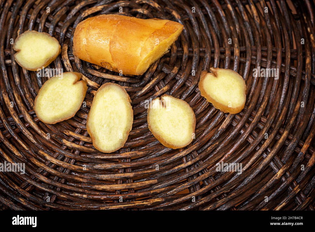 fragrant ginger on a dark background of intertwined twigs Stock Photo ...