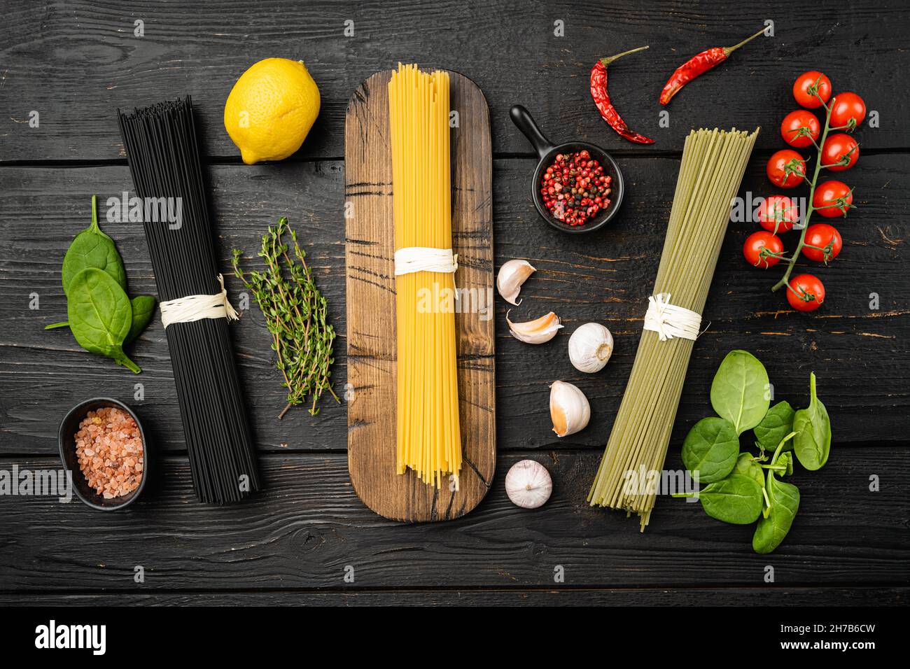 Multi colored pasta set, on black wooden table background, top view ...