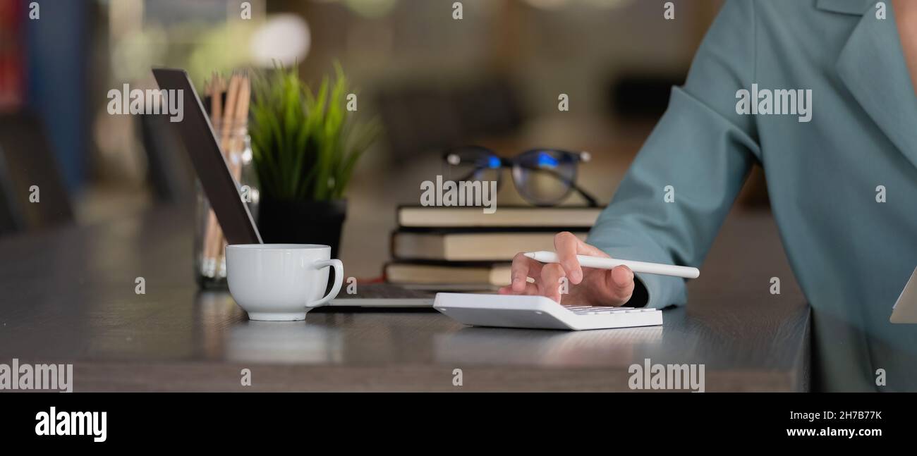 Close up businesswoman using calculator for analysis maketing plan ...