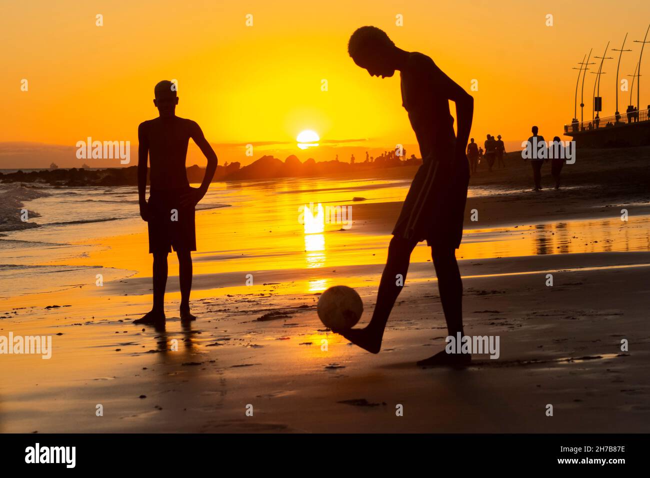 Young people playing sand football at sunset on Ondina beach in ...