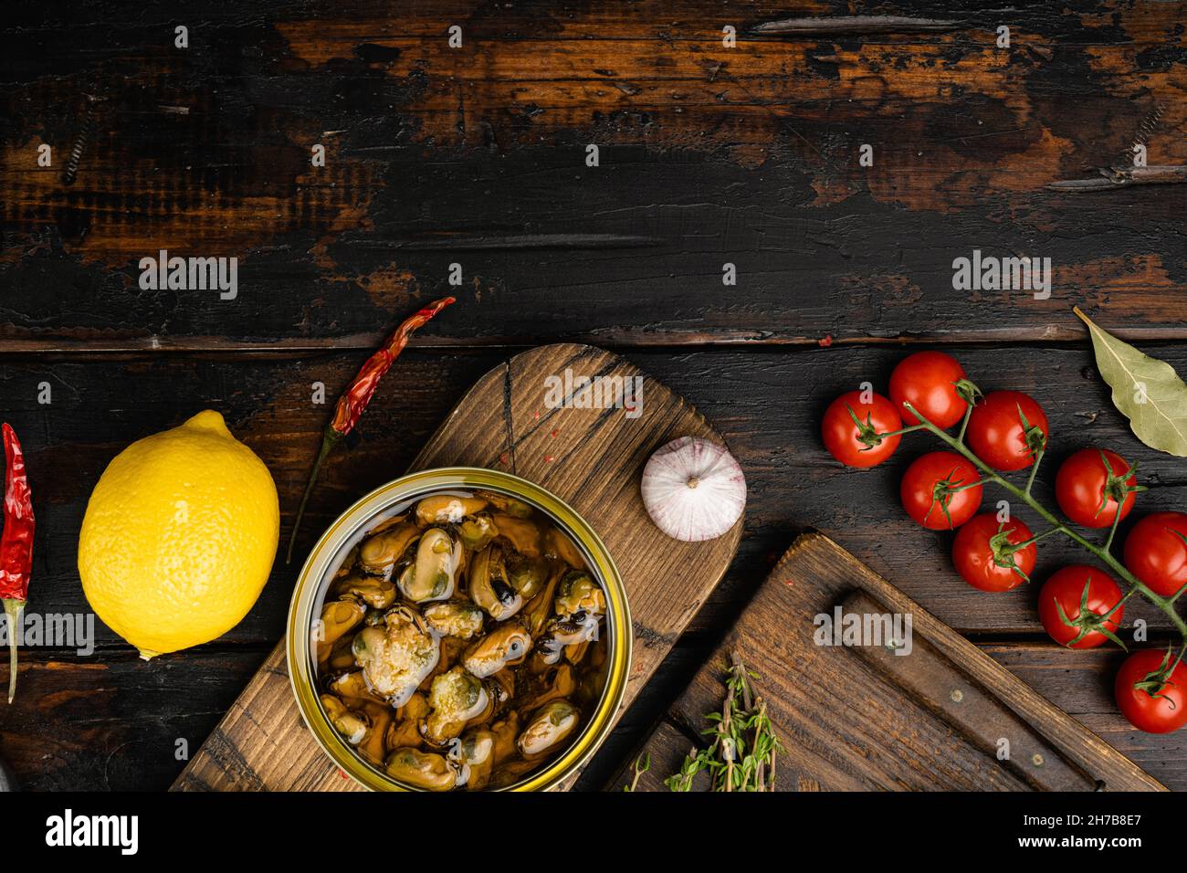 canned seafood mussels in oil set, on old dark wooden table background ...