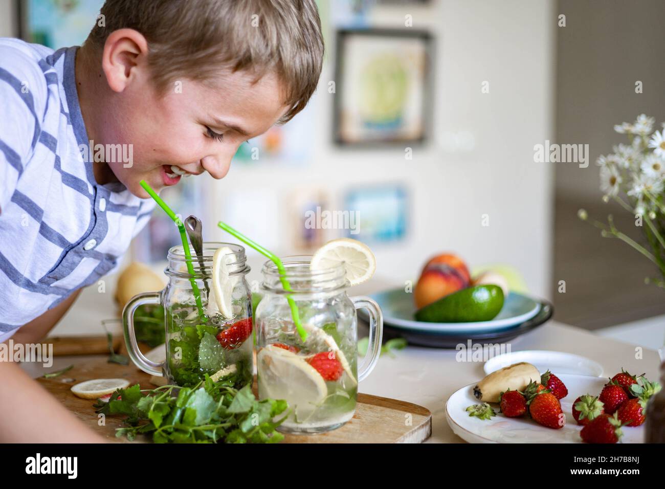Two laughing little boys drinking refreshing vitamin summer cocktail ...