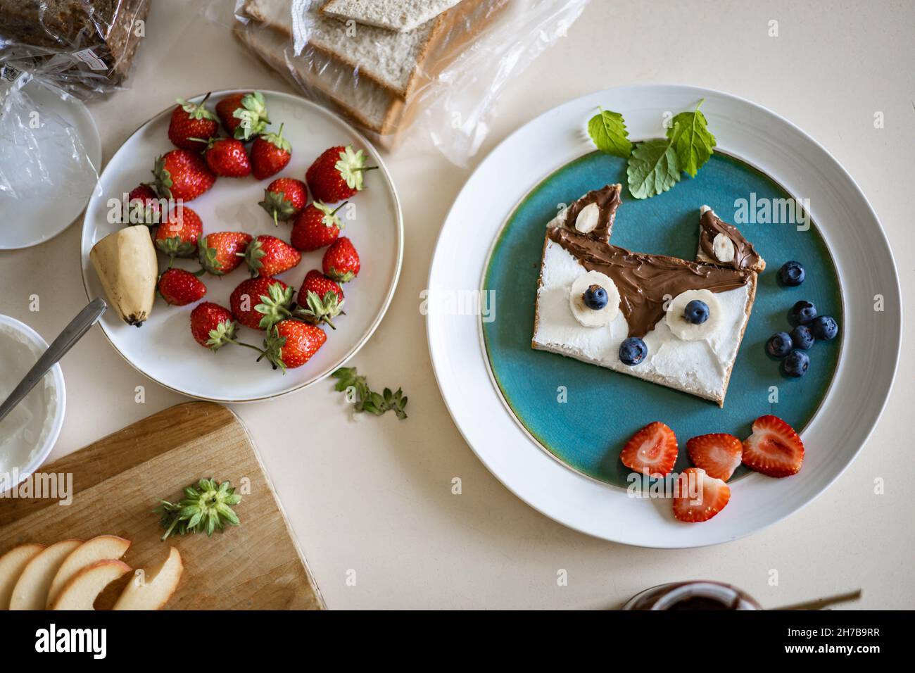 Top view childish sandwich with cottage cheese, chocolate paste, fruits ...