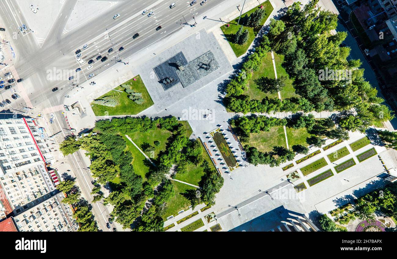 Aerial city view with crossroads, roads, houses, buildings, parks and ...