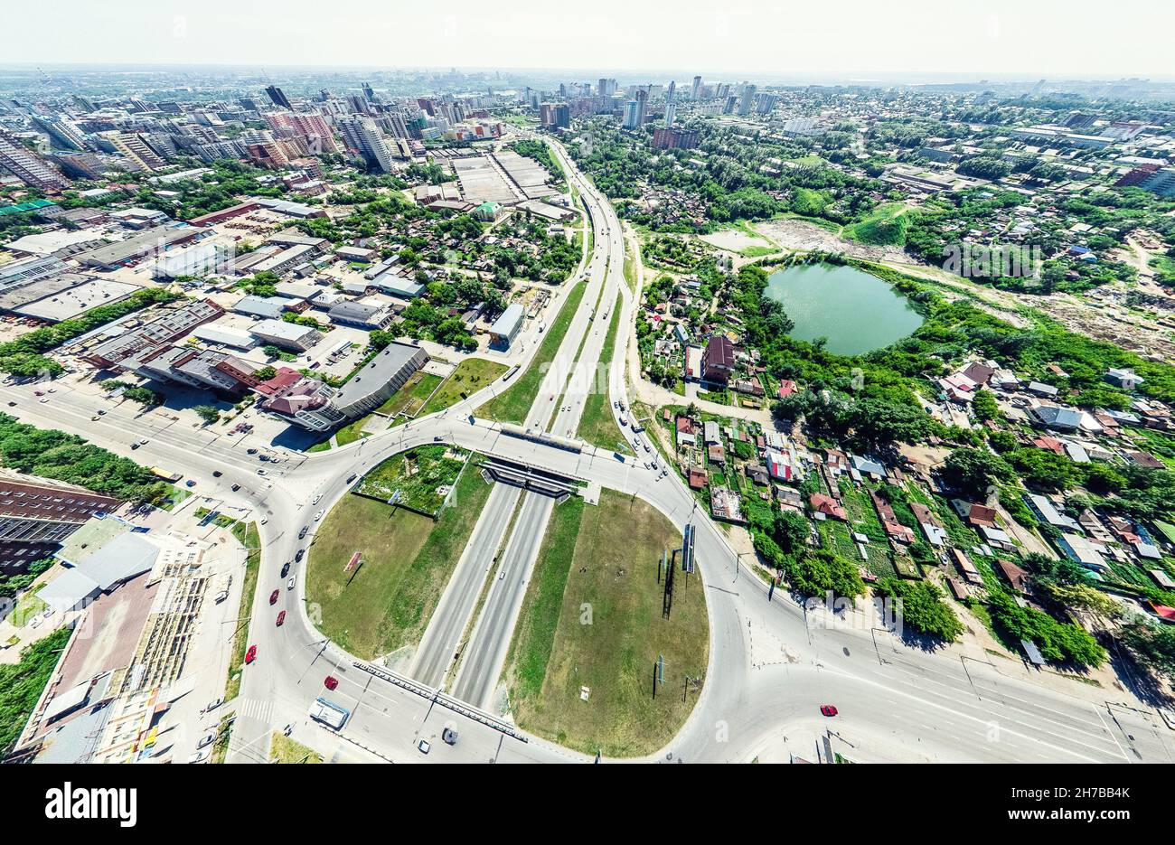 Aerial city view with crossroads and roads, houses, buildings, parks ...