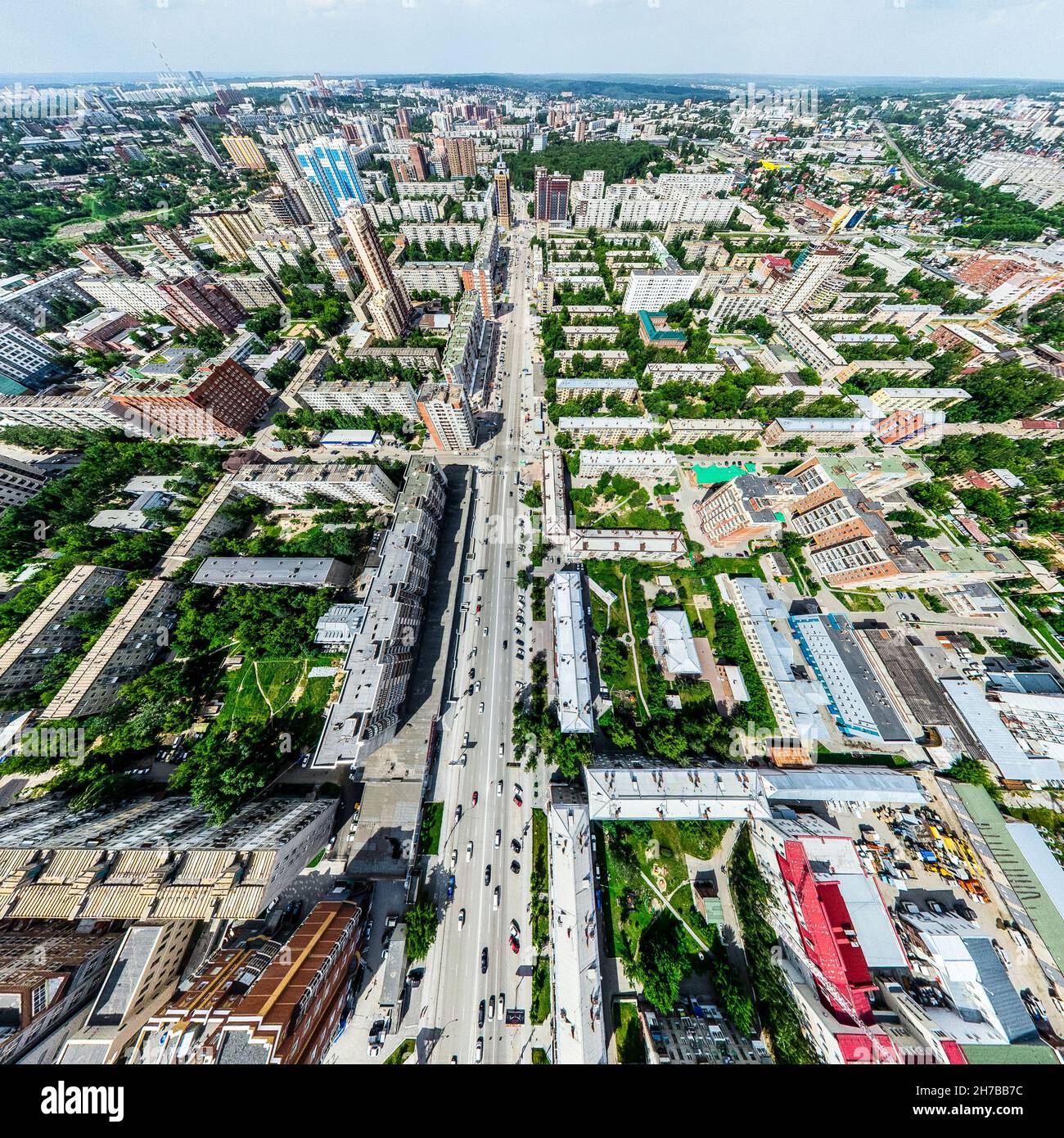 Aerial city view with crossroads and roads, houses, buildings, parks ...