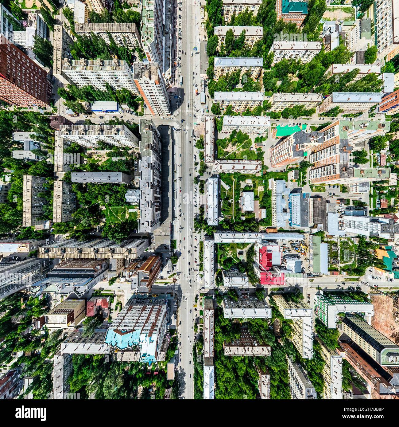 Aerial city view with crossroads and roads, houses, buildings, parks ...