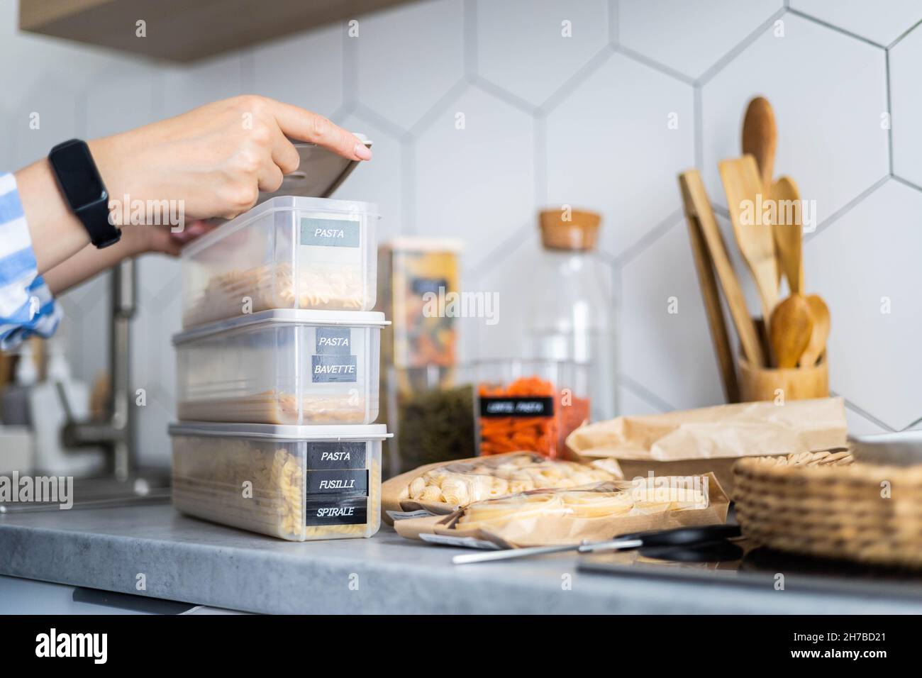 Closeup female hands placing and sorting pasta into pp boxes. Storage ...