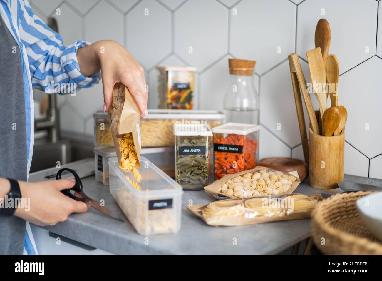 Closeup female hands placing and sorting pasta into pp boxes. Storage ...