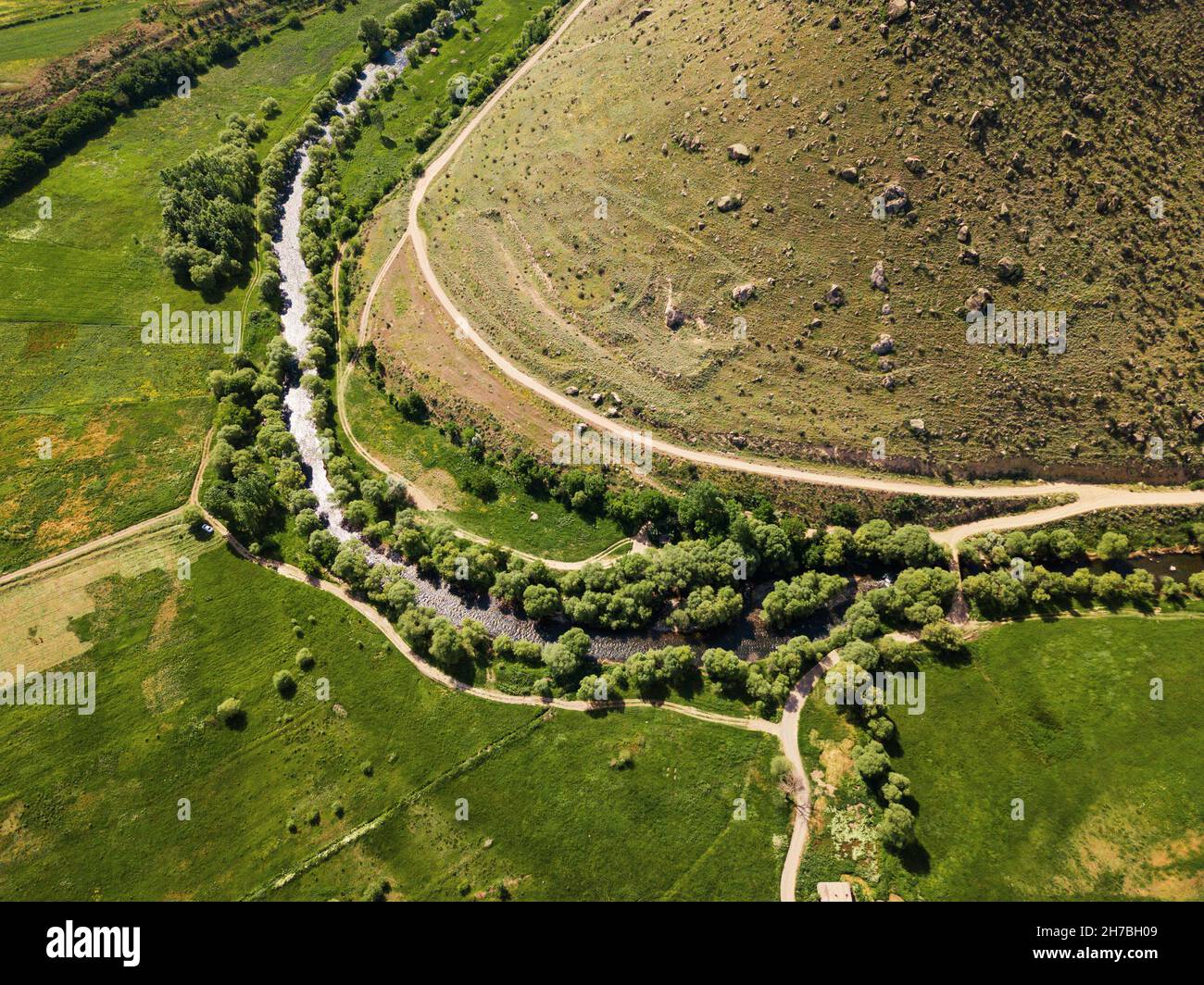 The bend and sharp turn of the river around the rocky mountain ...