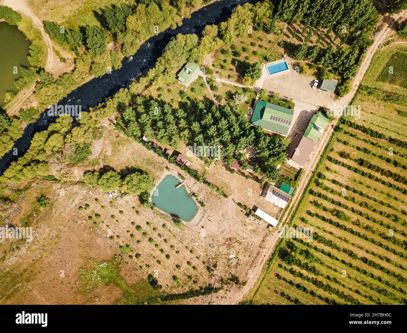 Aerial birds eye view of a small rural farm or camping with buildings ...