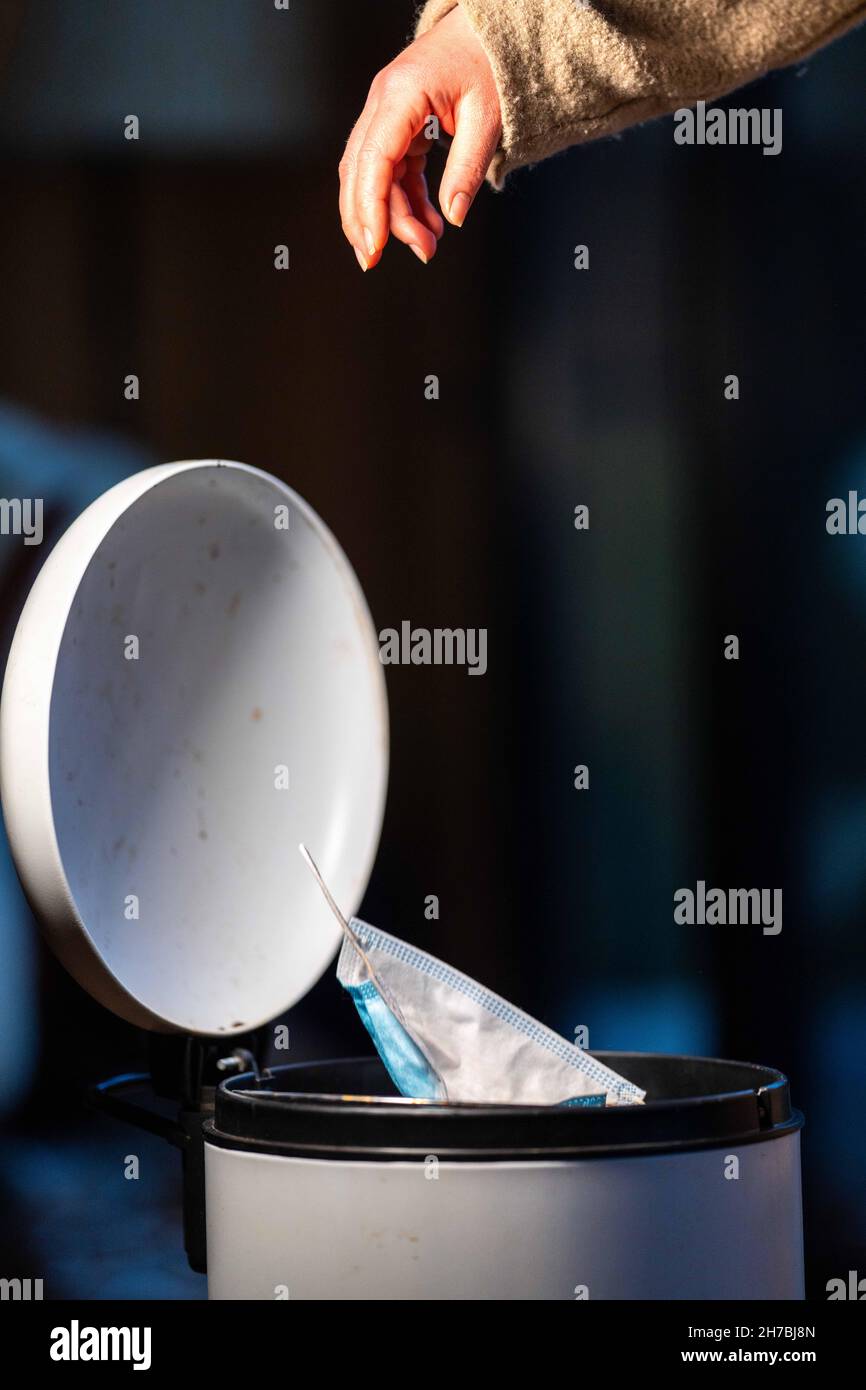 Dropping and throwing a covid 19 delta mask in a bin and the trash in ...