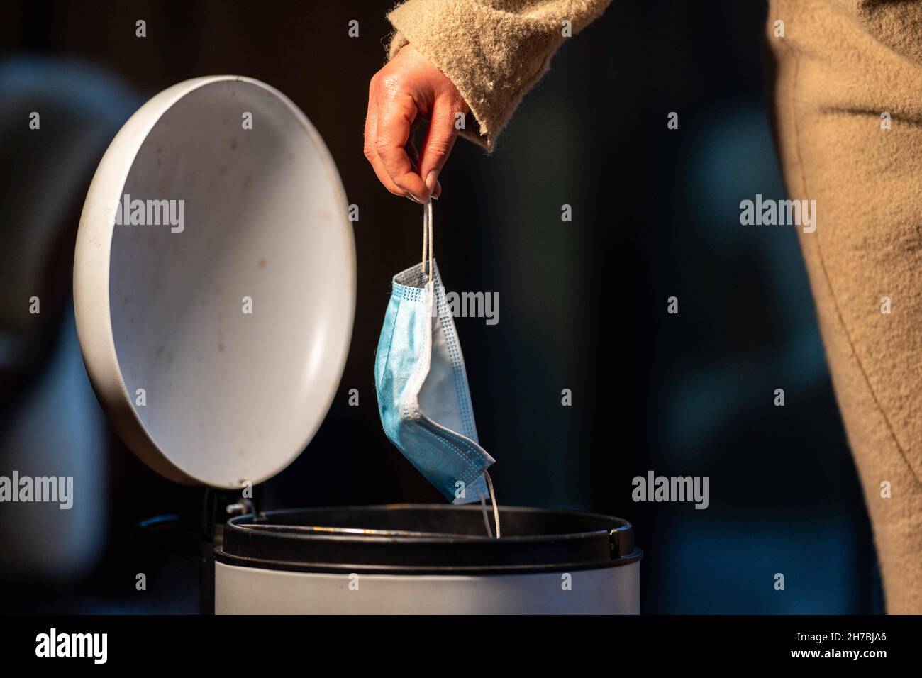 Dropping and throwing a covid 19 delta mask in a bin and the trash in ...