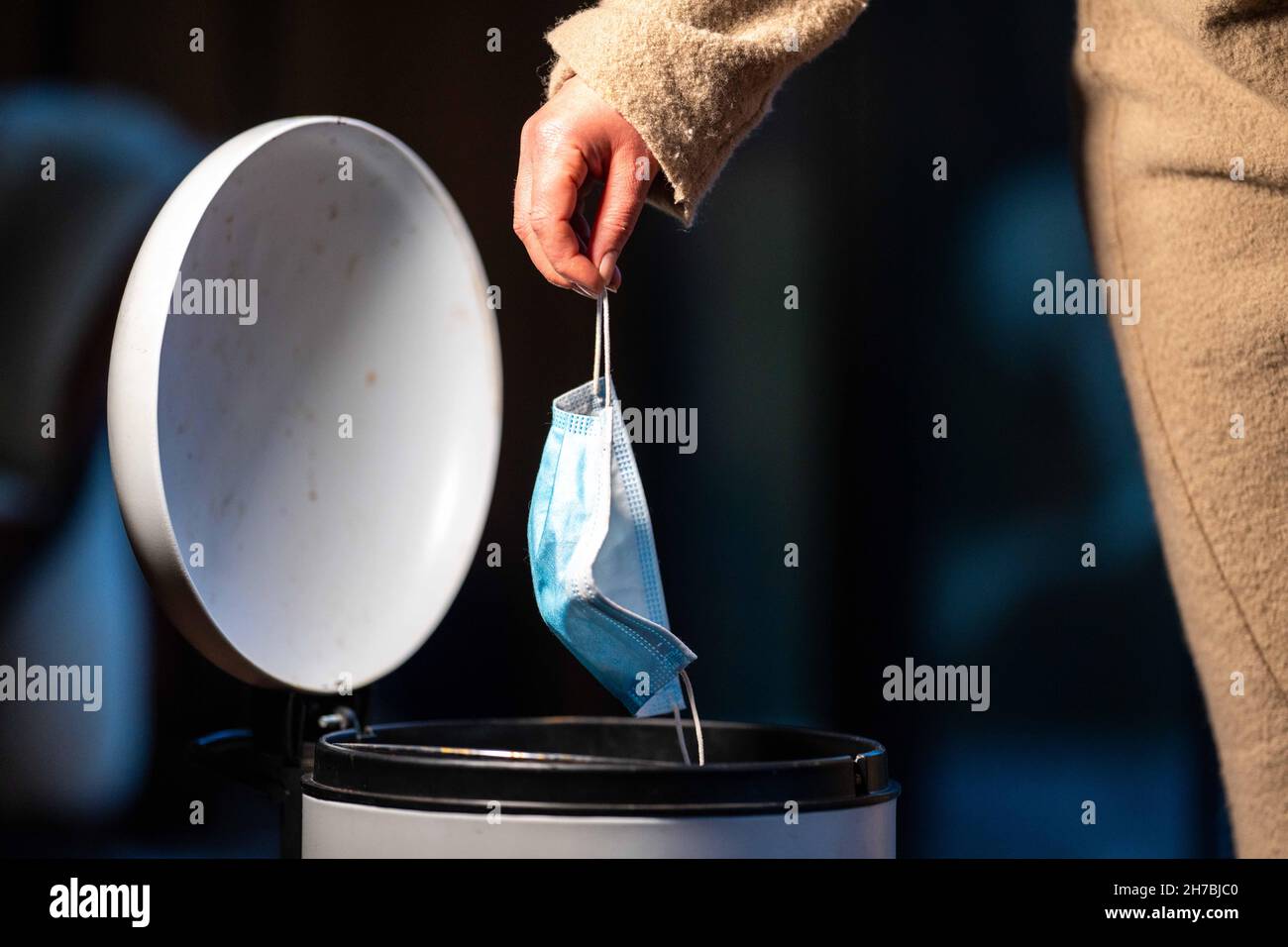 Dropping and throwing a covid 19 delta mask in a bin and the trash in ...