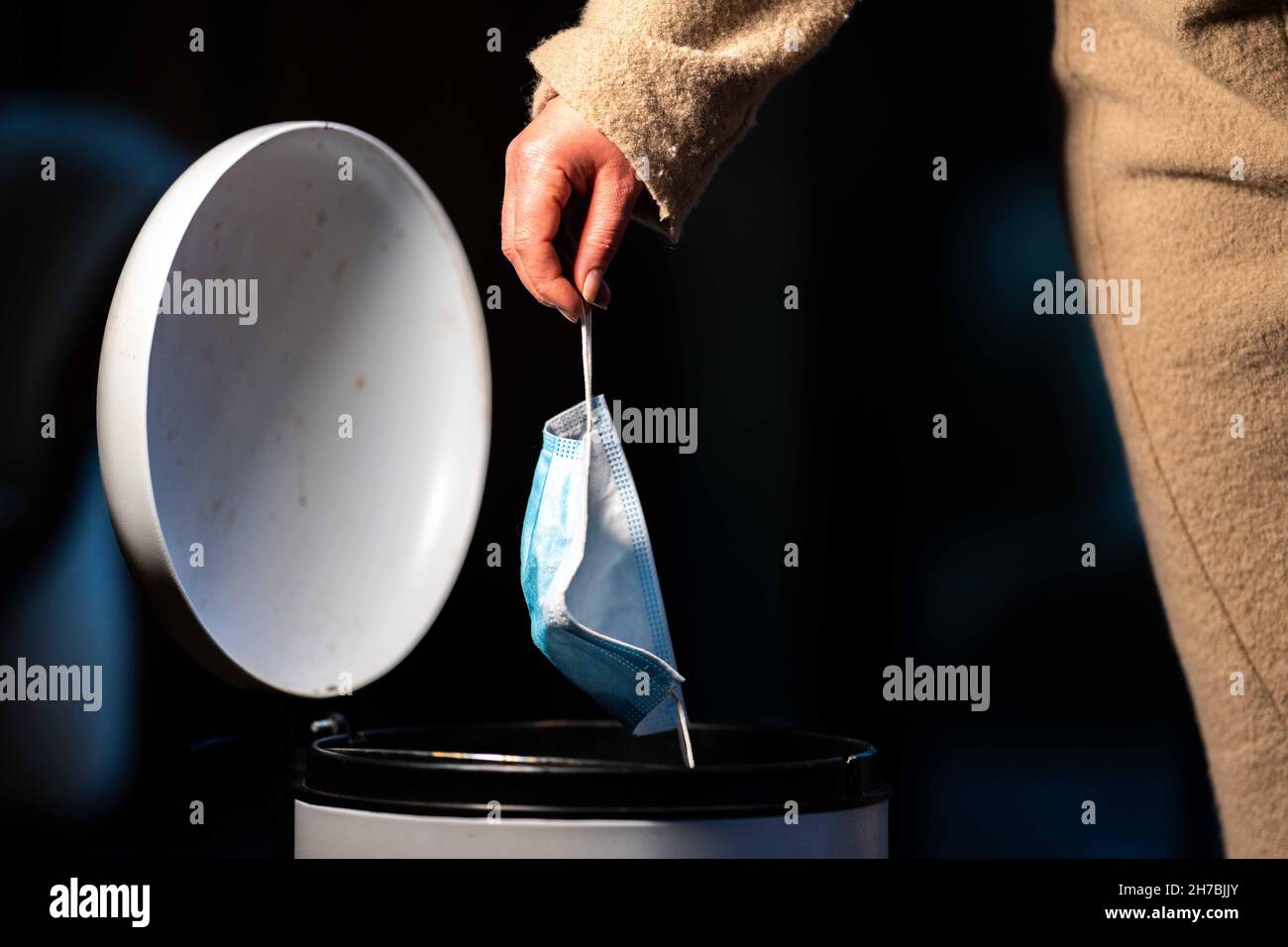 Dropping and throwing a covid 19 delta mask in a bin and the trash in ...