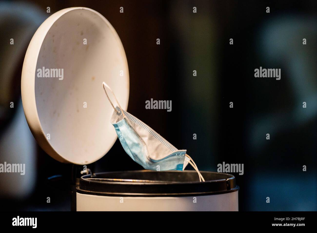 Dropping and throwing a covid 19 delta mask in a bin and the trash in ...