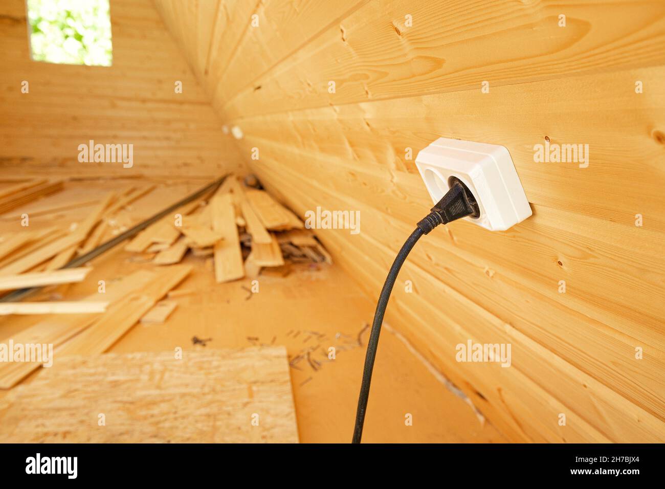 Electrical outlet in a wooden house under construction. The concept of ...