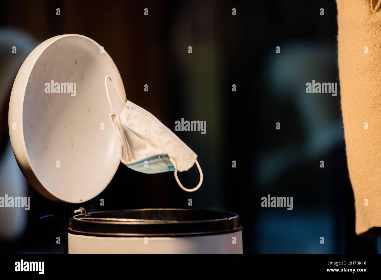 Dropping and throwing a covid 19 delta mask in a bin and the trash in ...