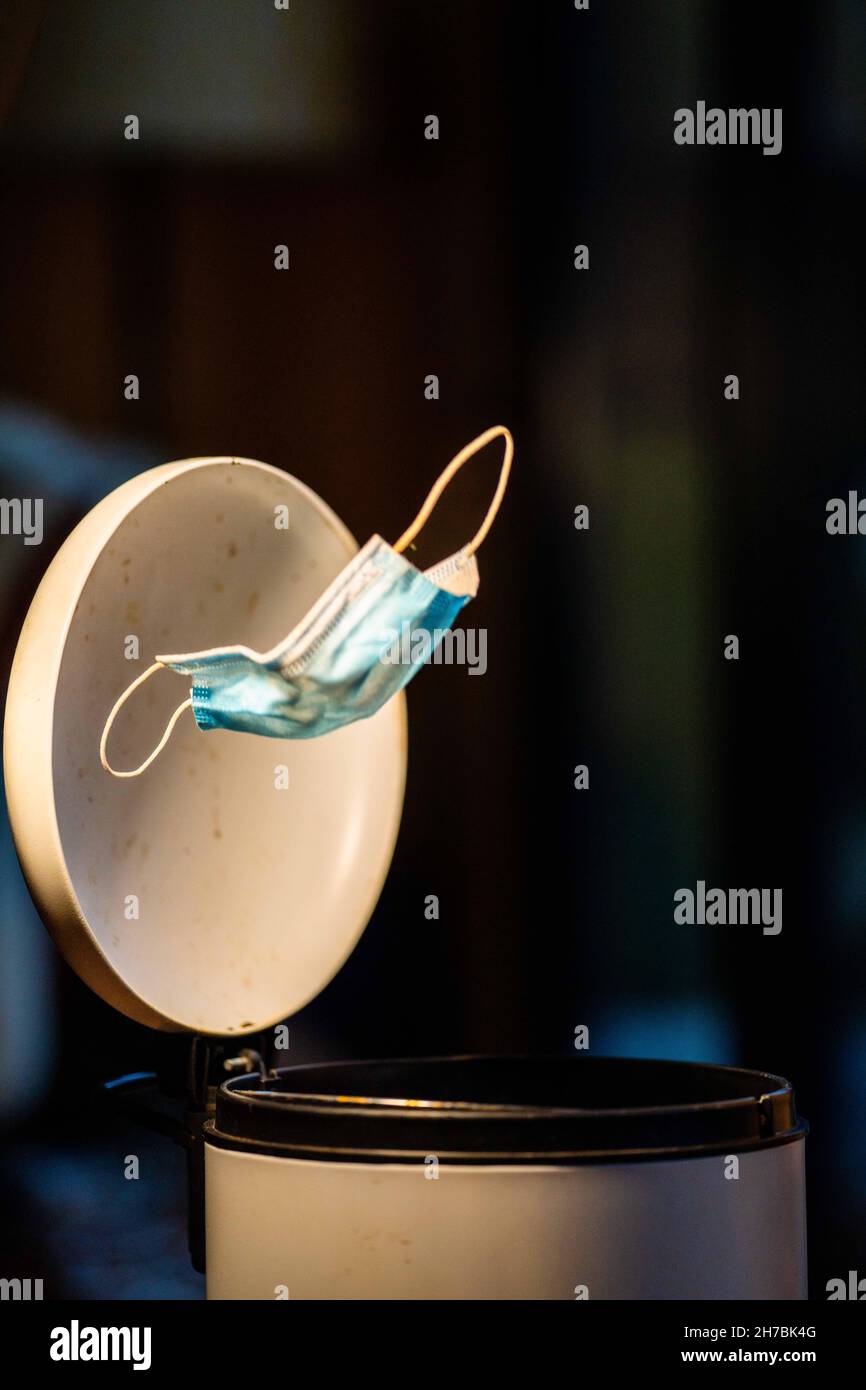 Dropping and throwing a covid 19 delta mask in a bin and the trash in ...