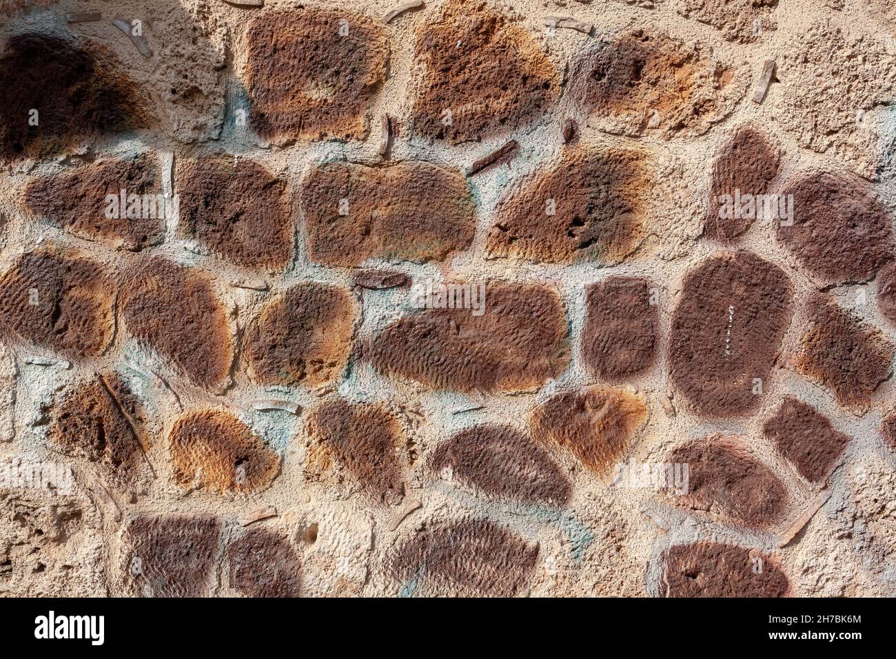 Smooth wall of old porous blocks of different sizes on cement mortar ...