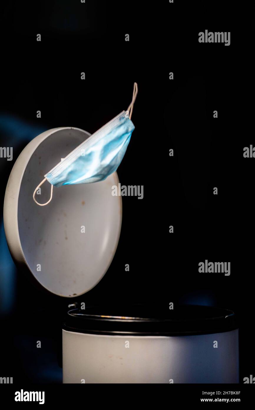 Dropping and throwing a covid 19 delta mask in a bin and the trash in ...