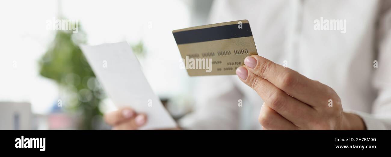 Credit plastic bank card and check in female hands Stock Photo - Alamy