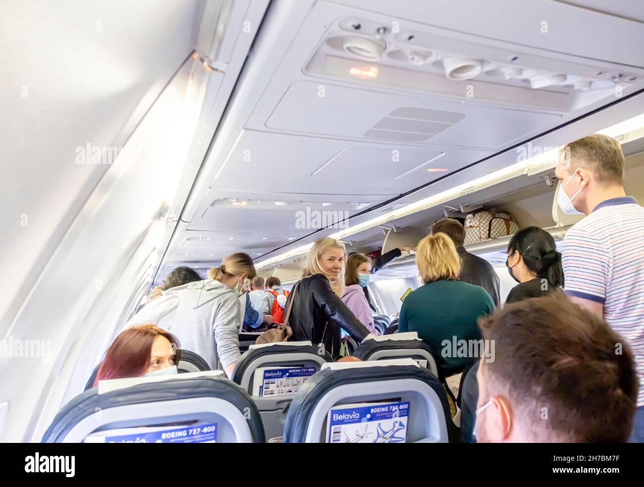 Passengers in face masks leaving a Belavia Boeing 737-800 plane Stock ...