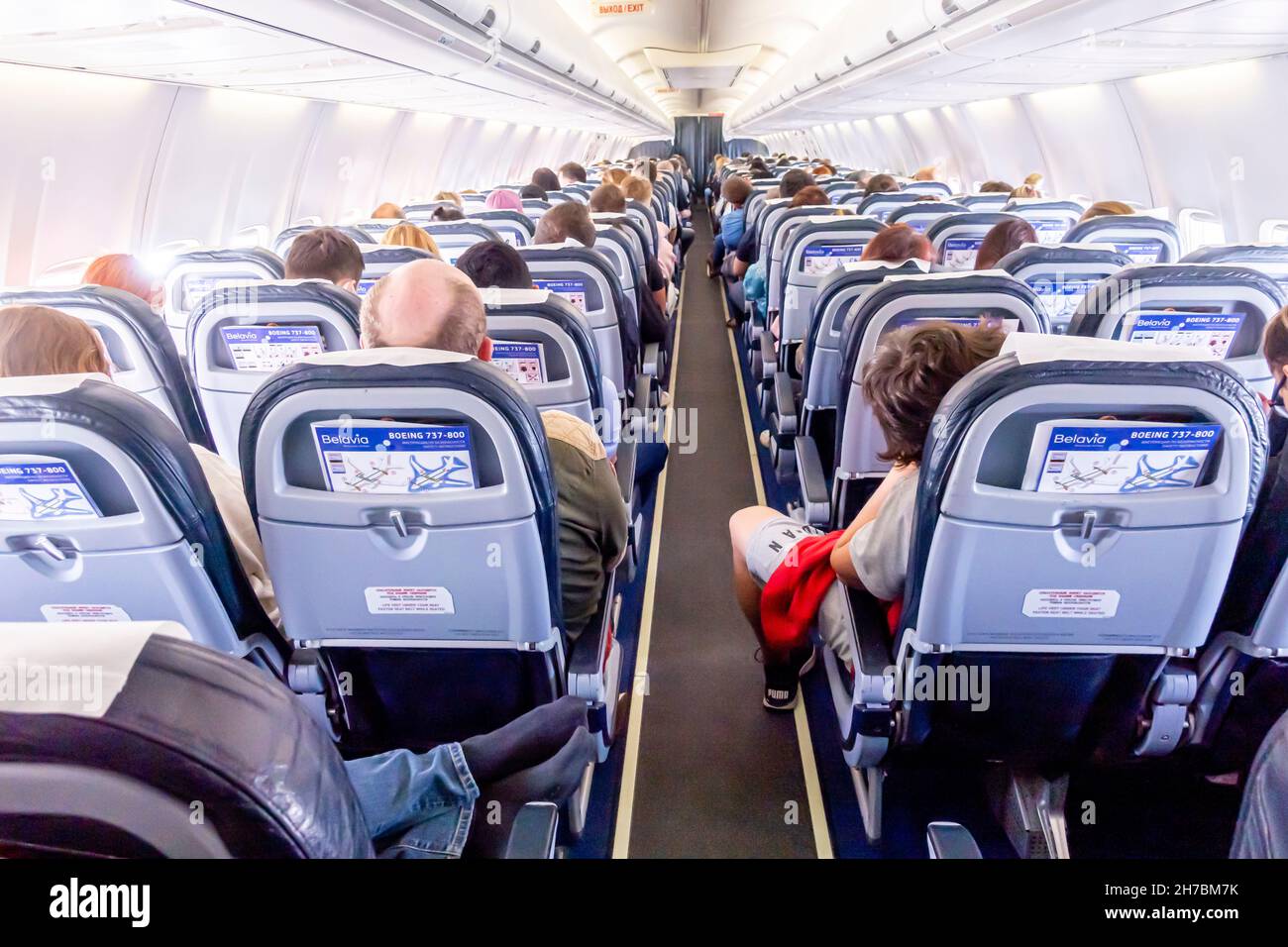 Back view of passengers sleeping in an airplane cabin of a Belavia ...