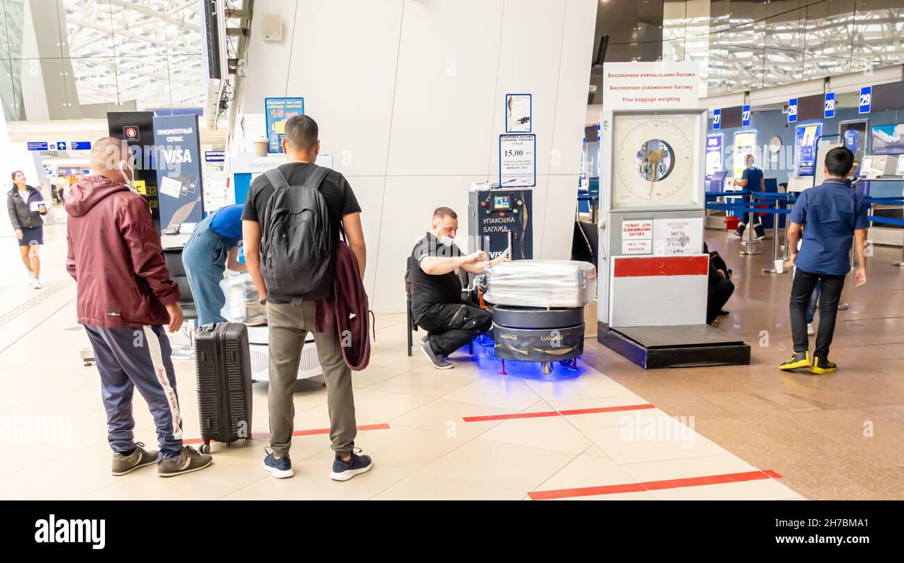 Baggage Wrapping zone, station, machine, and personnel with passengers ...