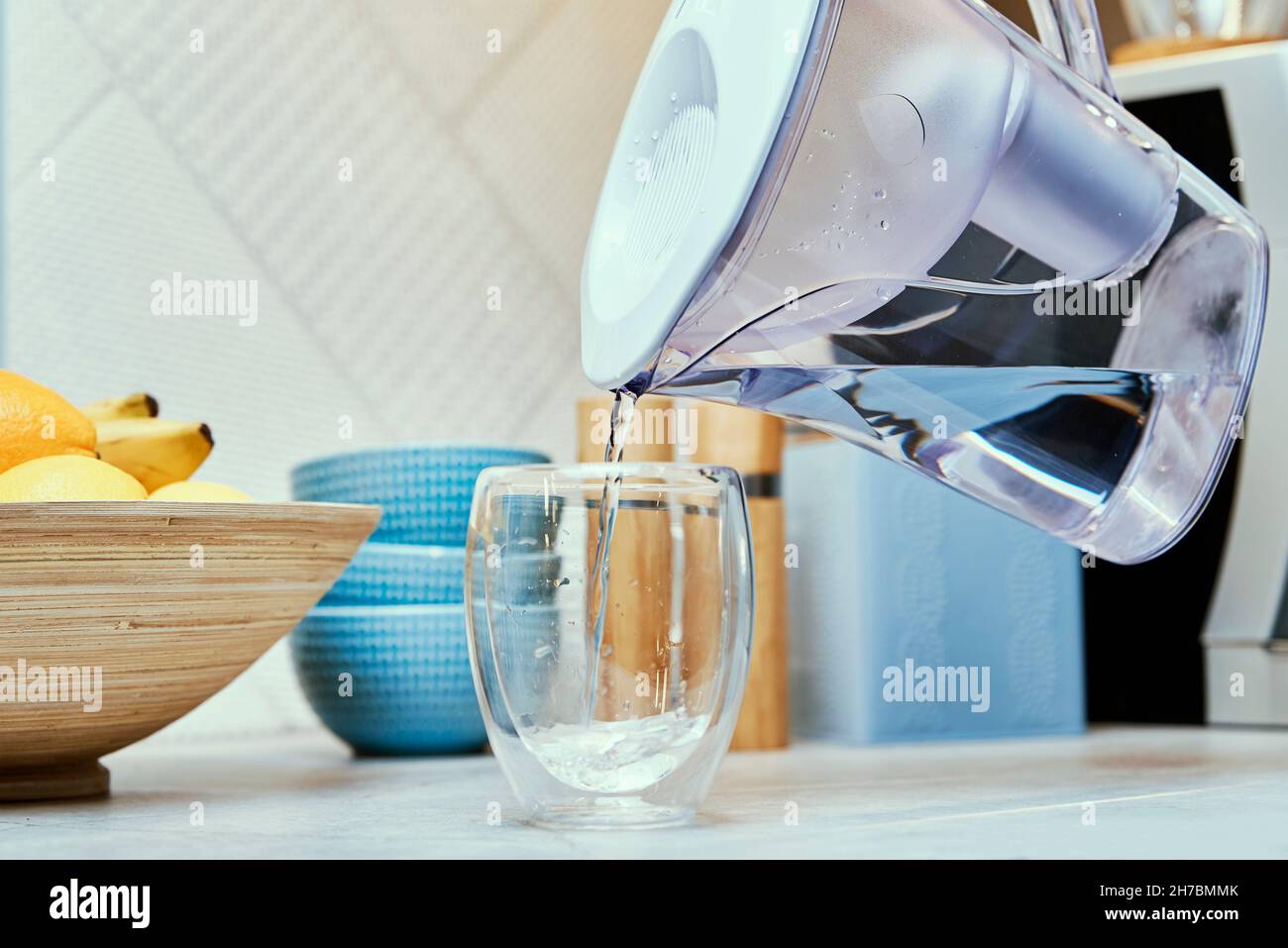 Water pouring from water filter into a glass, close up Stock Photo - Alamy