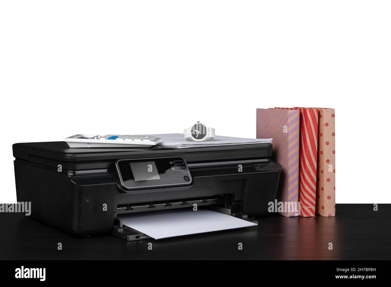 Printer and stack of books on black table against white background ...