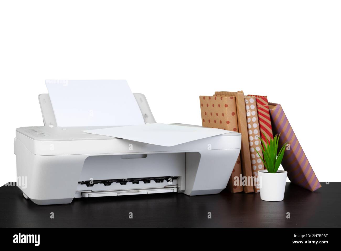 Printer and stack of books on black table against white background ...
