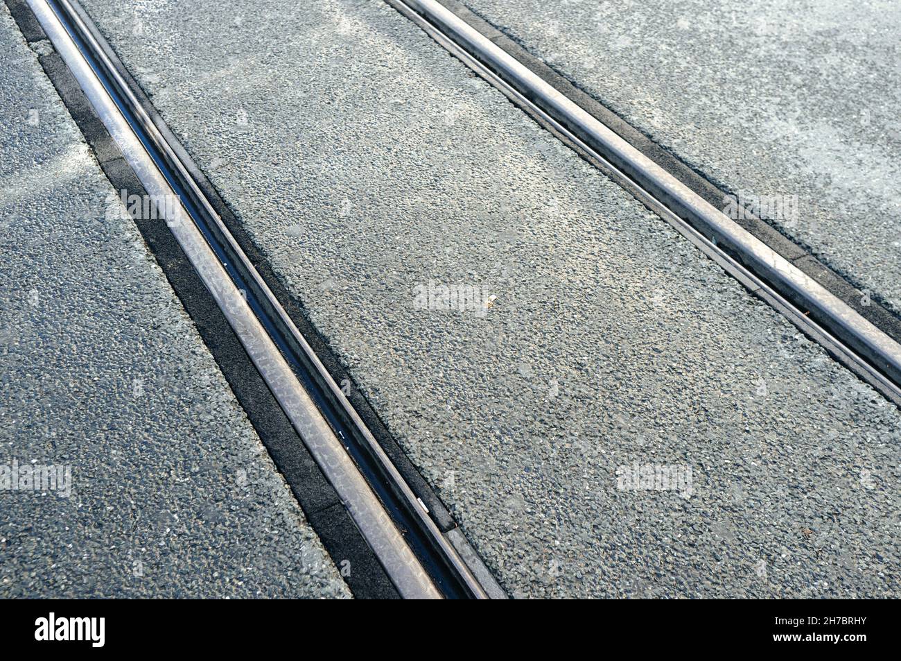Running metal rails of modern tramway on pavement Stock Photo - Alamy