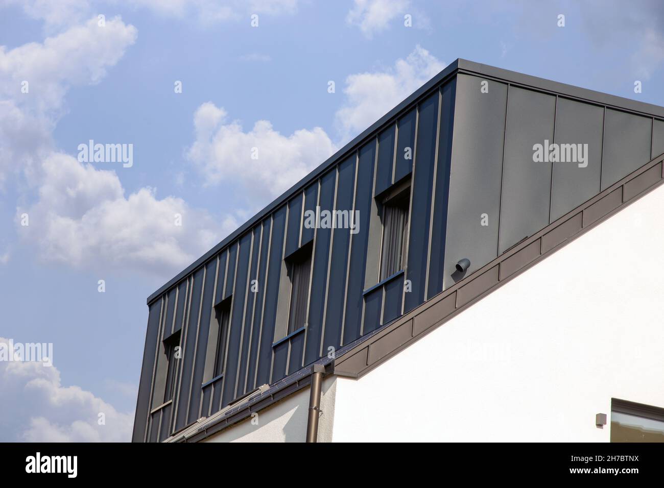 Newly tiled roof with large dormer with standing seam cladding Stock ...