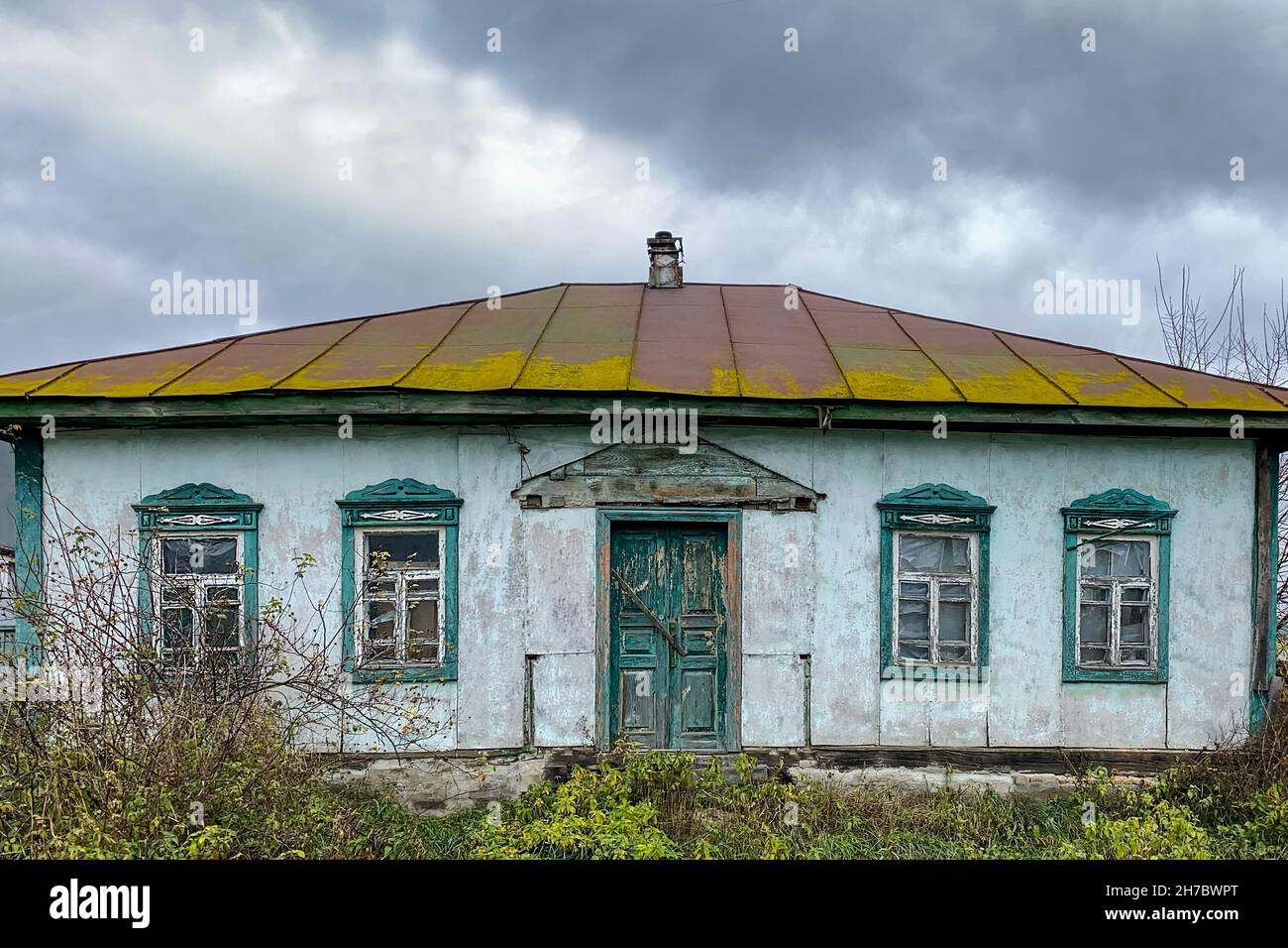 Old empty abandoned house with wooden windows in village or countryside ...