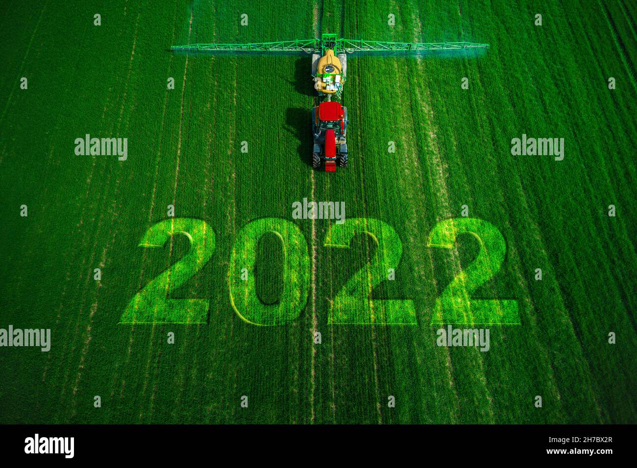 2022 Happy New Year concept and Aerial view of farming tractor plowing ...