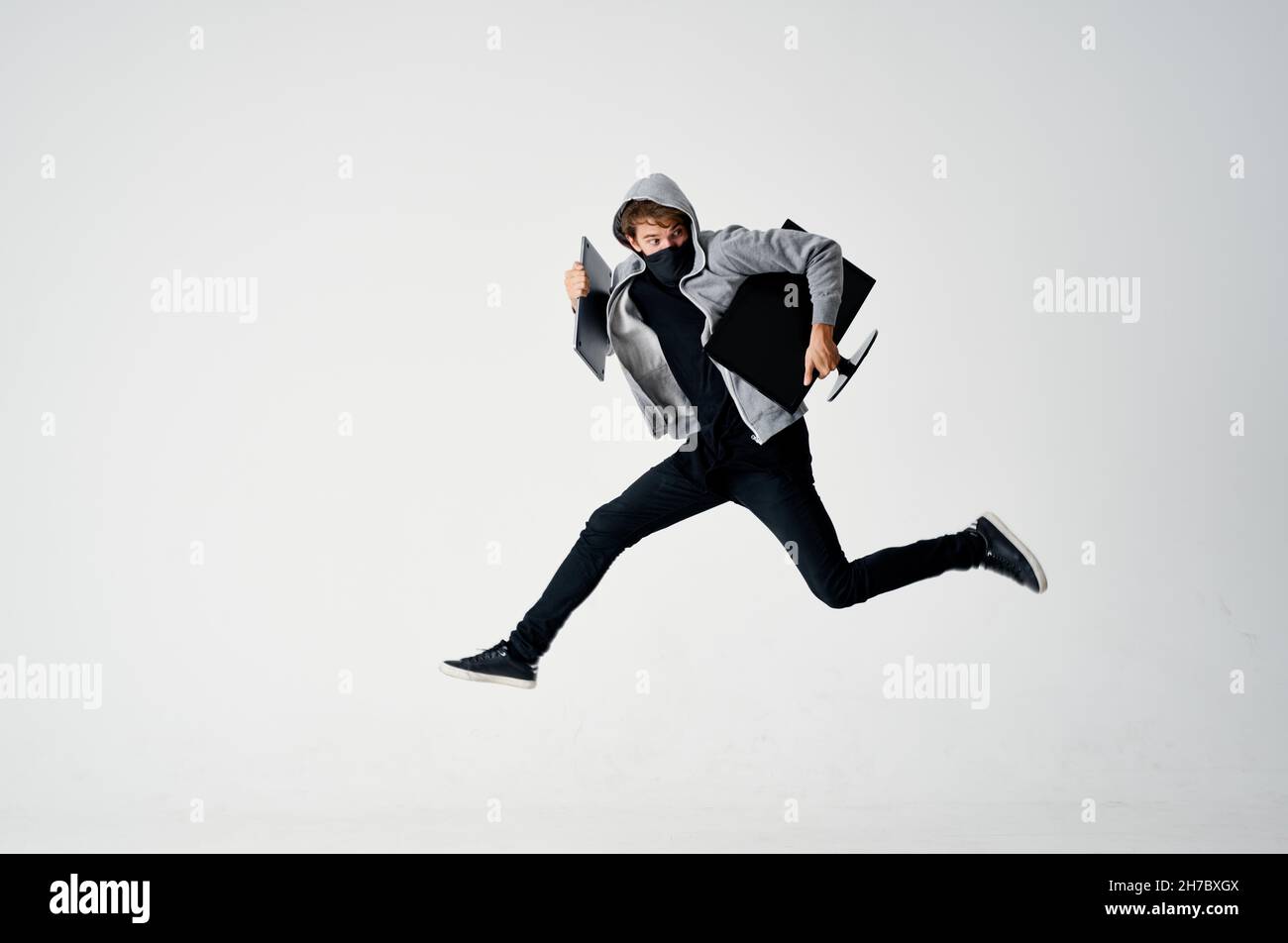 male thief stealth technique robbery safety hooligan light background ...