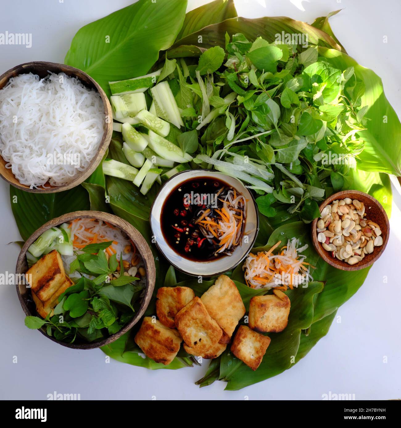 Top view vegan food ready to eat on leaf background, fried tofu, bun ...