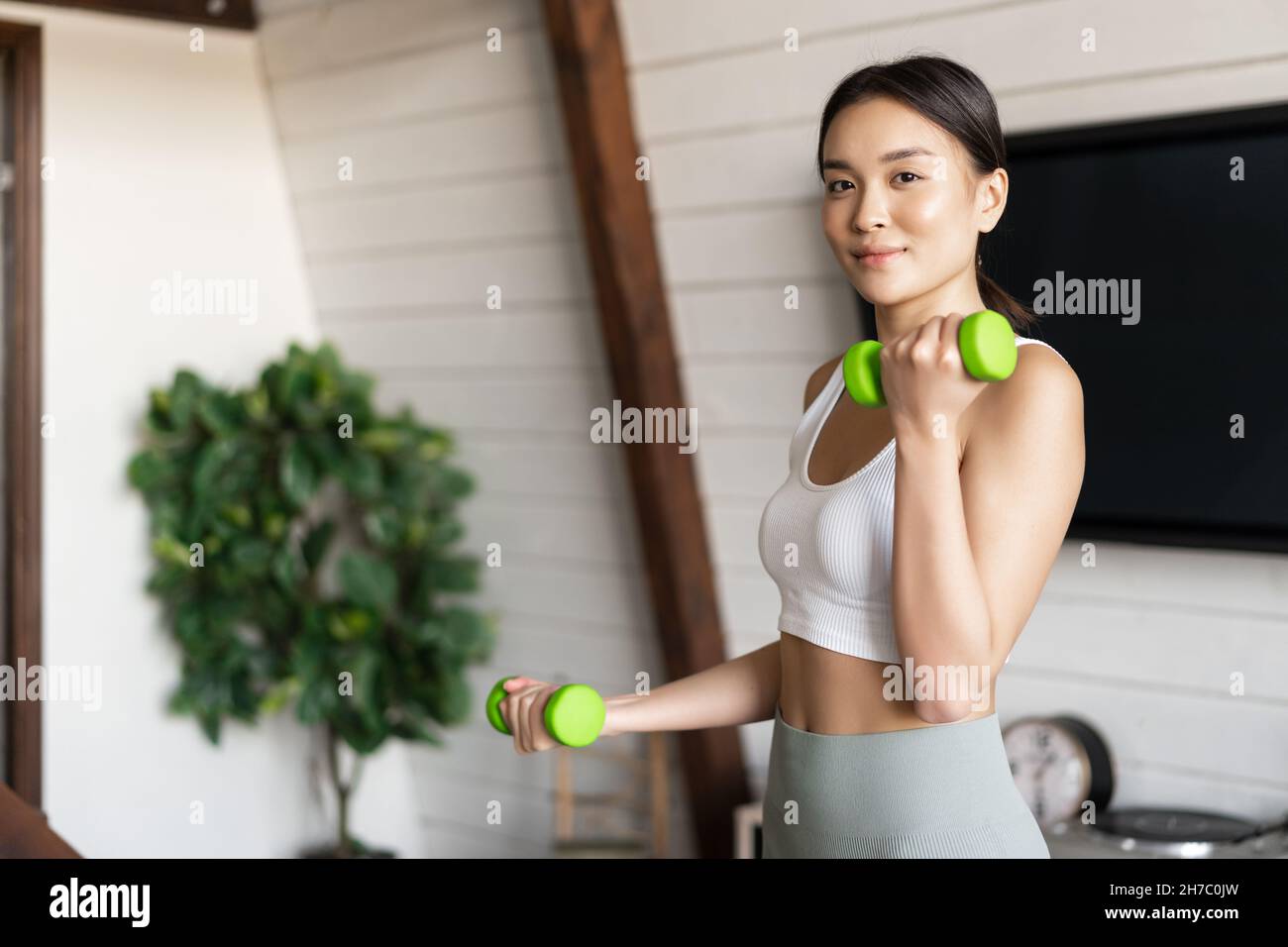 Active and healthy asian girl with fit body doing fitness exercises at ...