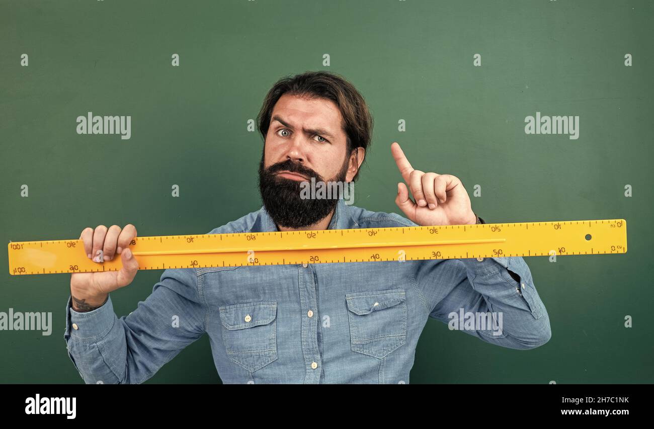 man serious with size measured on ruler math tool, inspired teacher ...