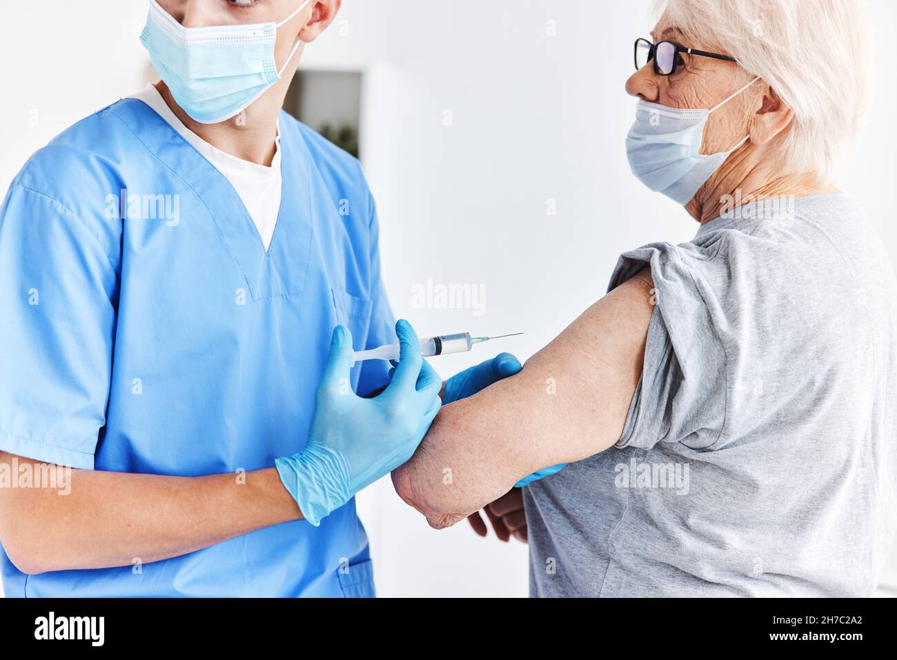 elderly woman next to the doctor arm injection vaccine passport ...