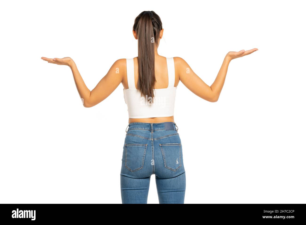 rear view of a young beautiful woman holding imaginary objects in her ...