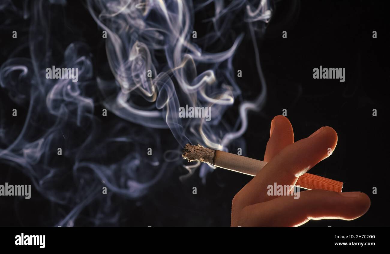 Smoke and choke. Cigarette smoke dark background. Steaming cigarette in ...