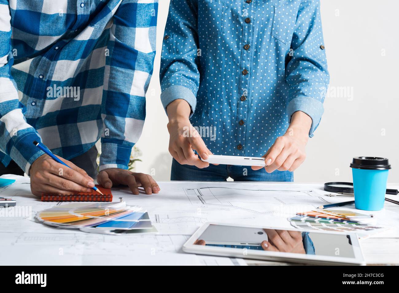 Woman taking photo of technical drawing Stock Photo - Alamy