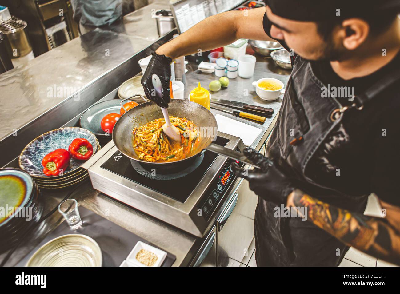 street food. fried noodles in a wok with chicken and shrimp on the wok ...