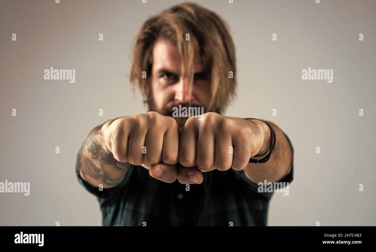 mature brutal hipster with lush moustache in shirt showing fists, punch ...