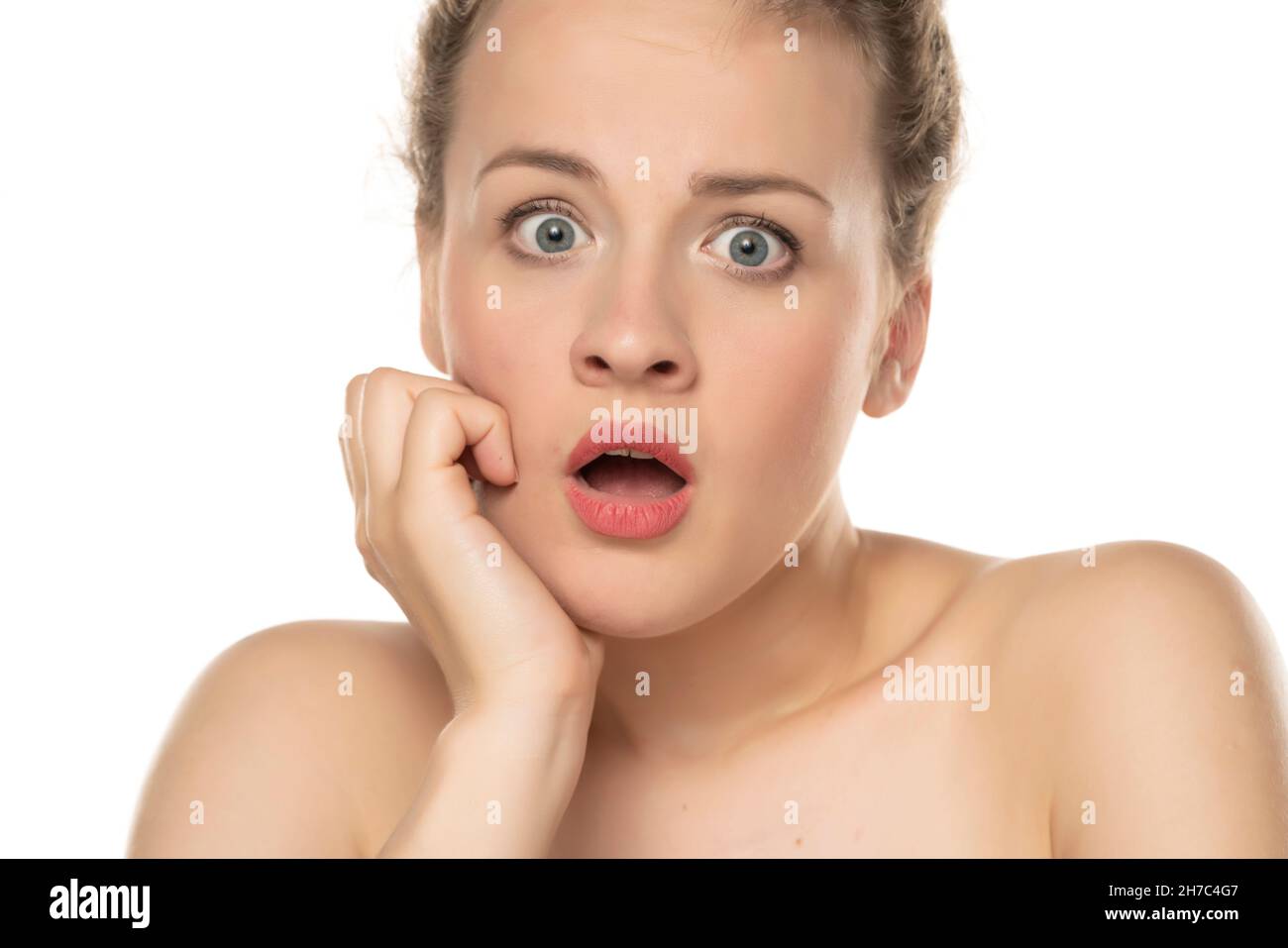 portrait of a young unpleasently surprised and shocked blonde on a ...