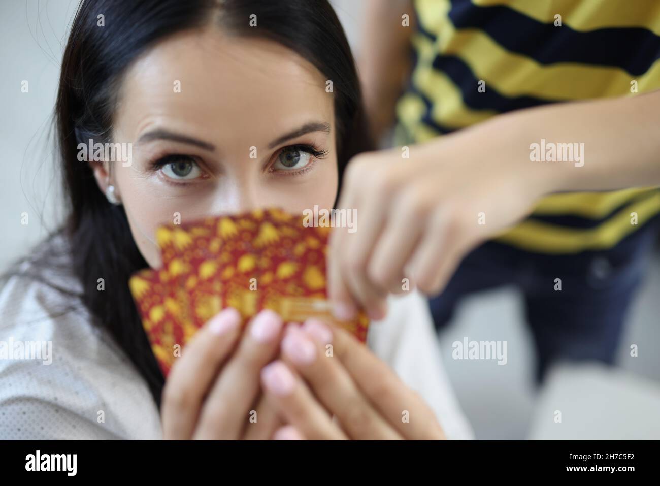 Mother playing card game with son and bluffing to win Stock Photo - Alamy