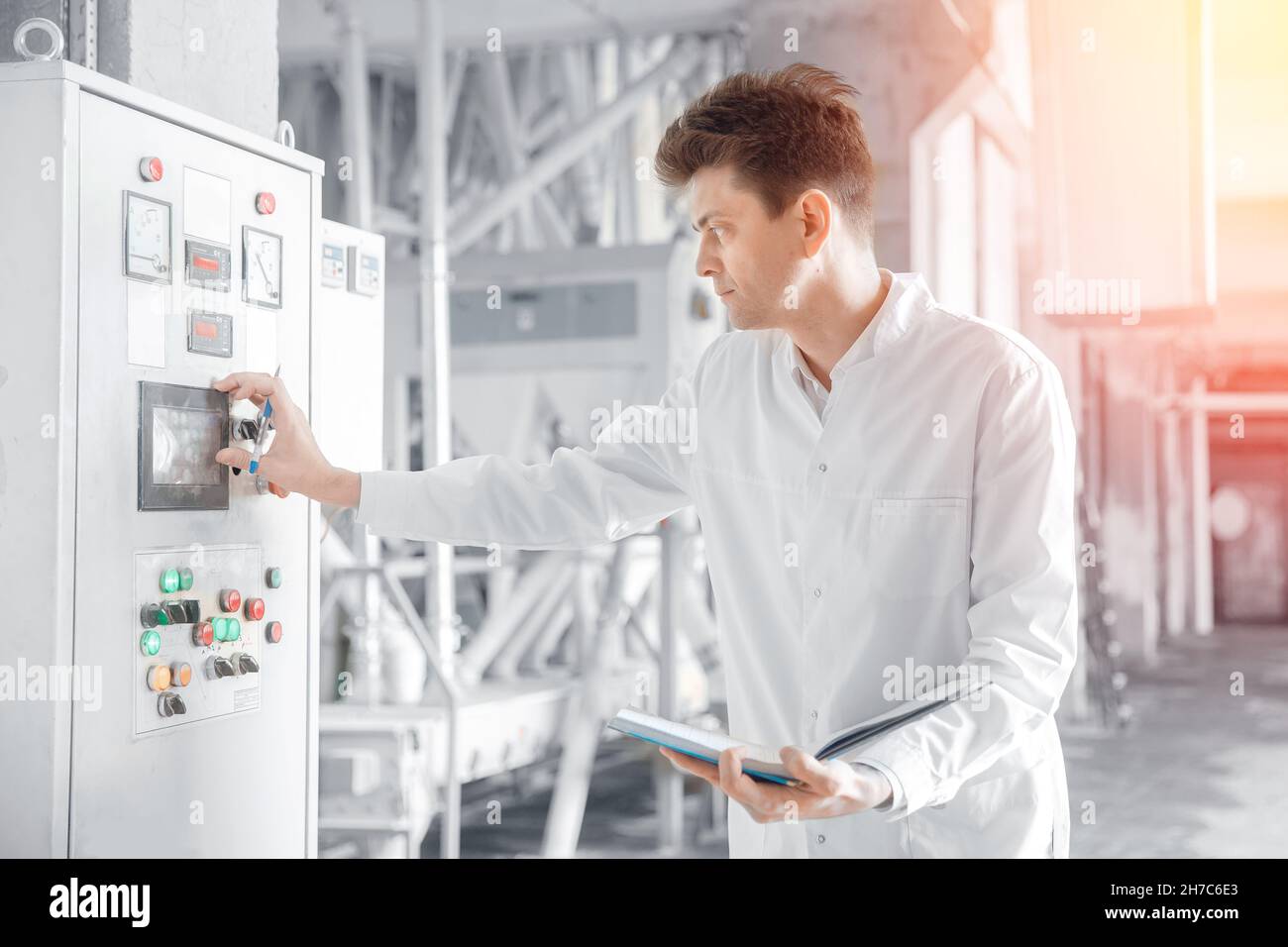 Male operator engineer performs process production line from control ...