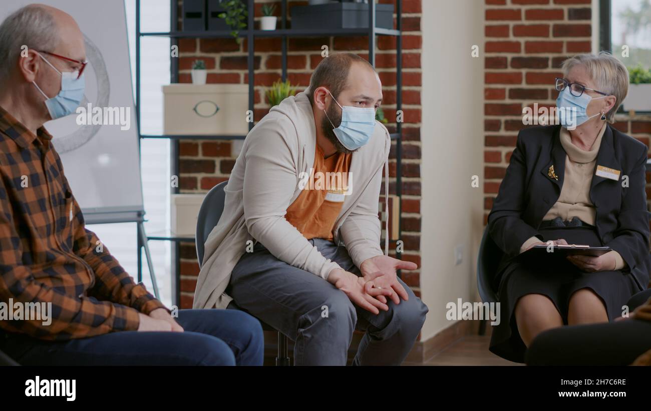 Man with anger manangement issues talking to psychiatrist at aa therapy ...